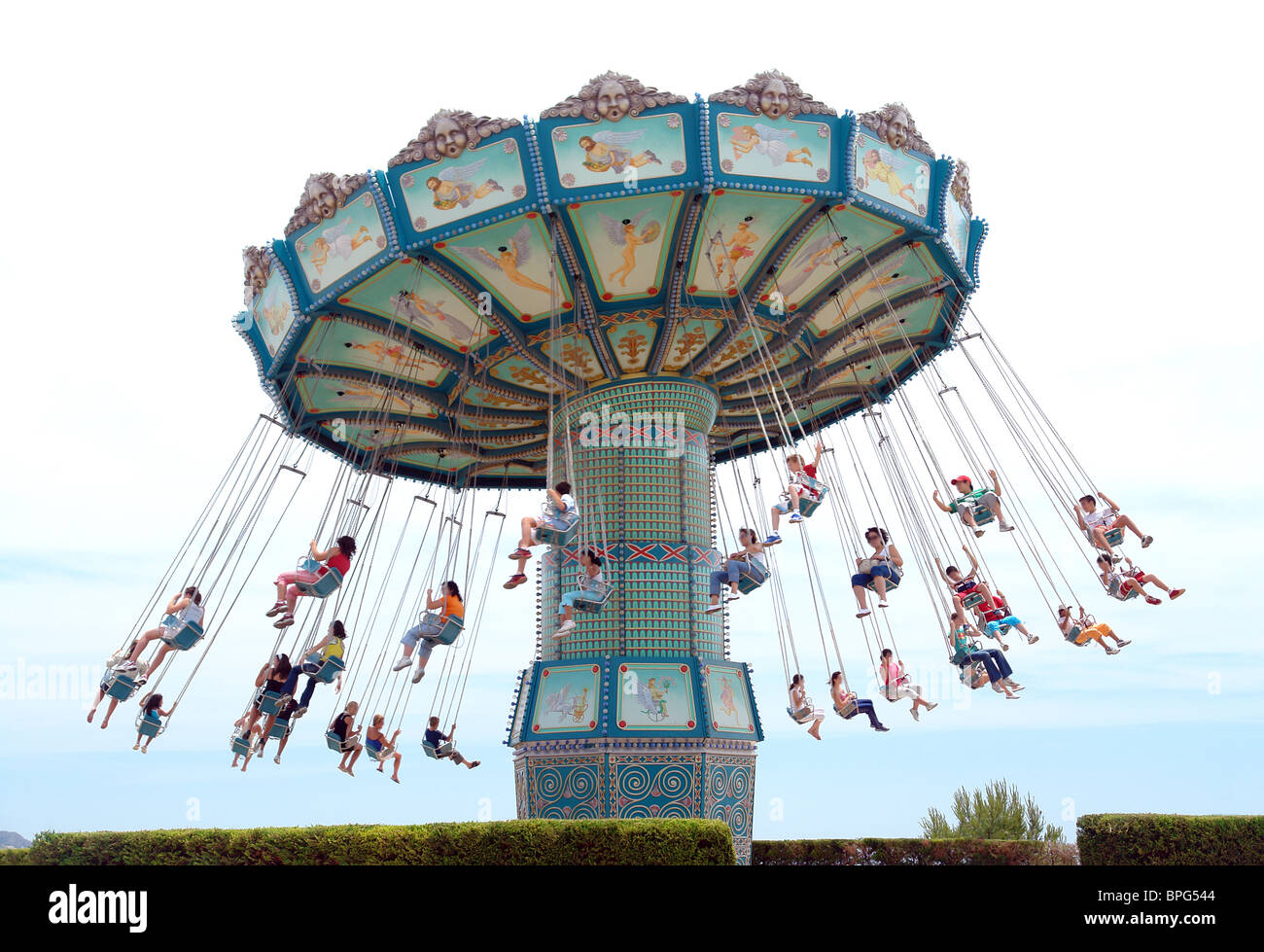 people having fun with riding a modest carousel Stock Photo - Alamy