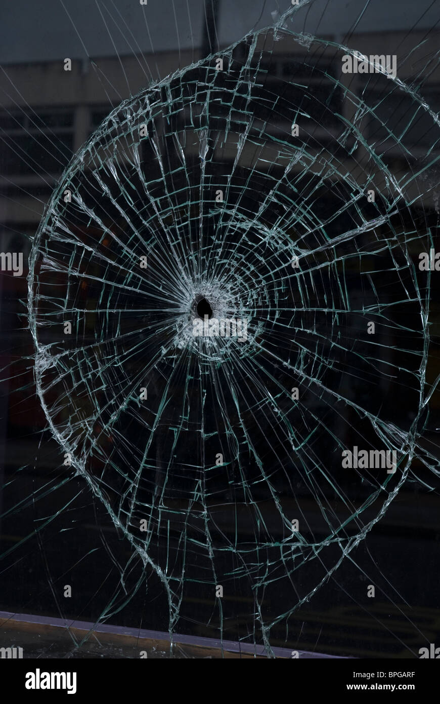 Window shattered by a stone, West London UK Stock Photo - Alamy