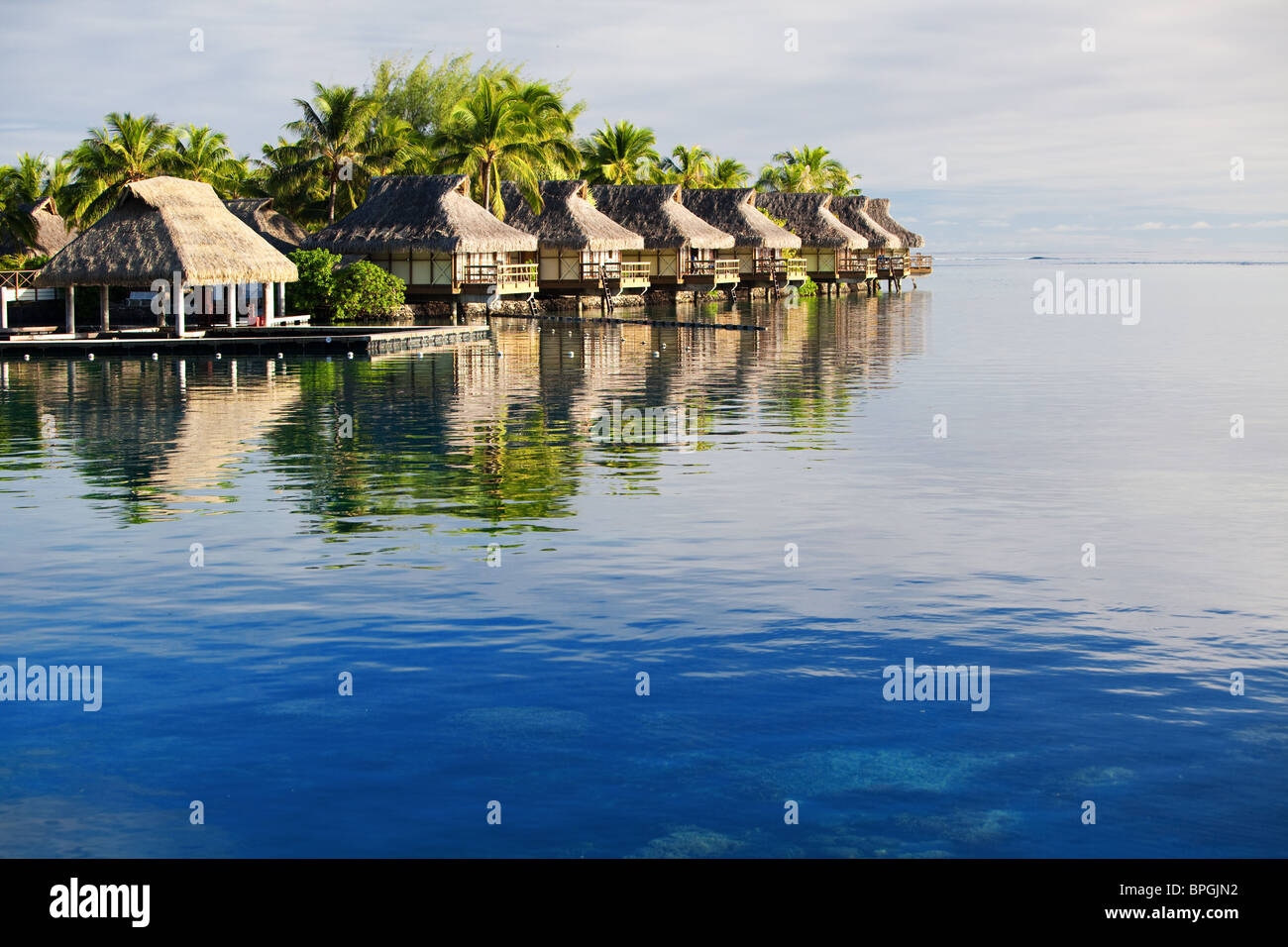 Amazing tropical resort with huts over blue water Stock Photo - Alamy