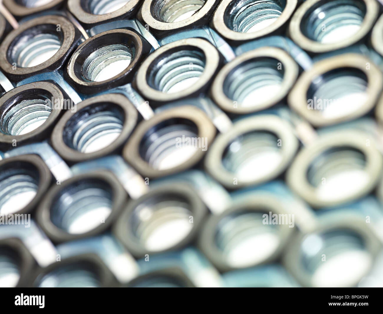 screw bolts on reflective white surface. Horizontal shape, selective ...