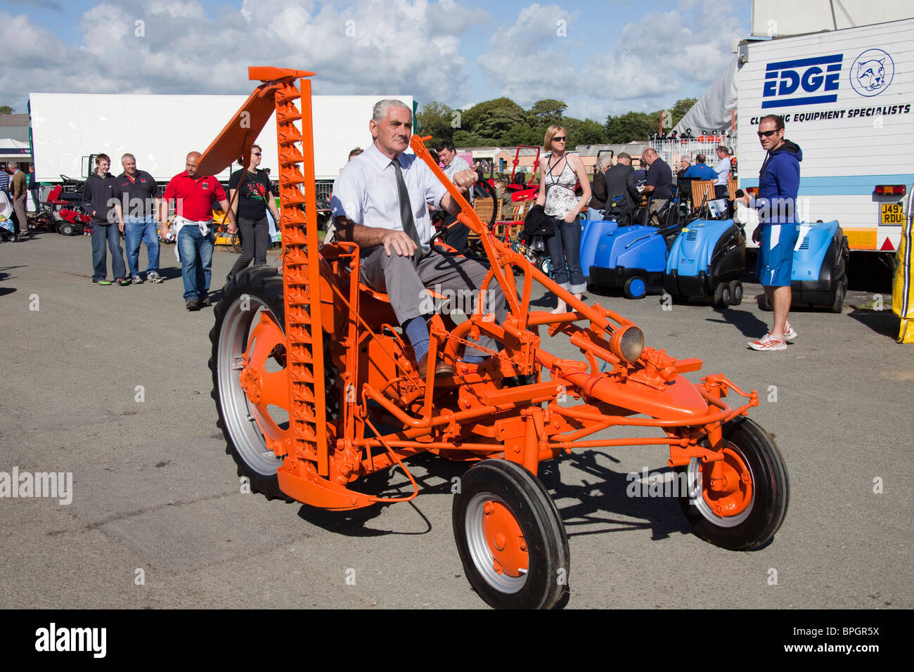 Vintage orange grass cutter mower tractor machinery parade at ...