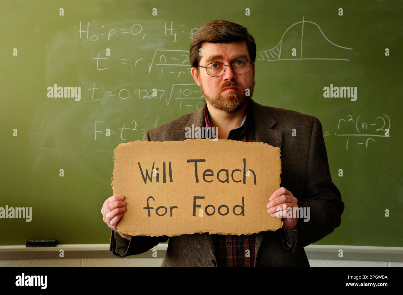 Professor or teacher in classroom holding a "Will Work for Food" sign ...
