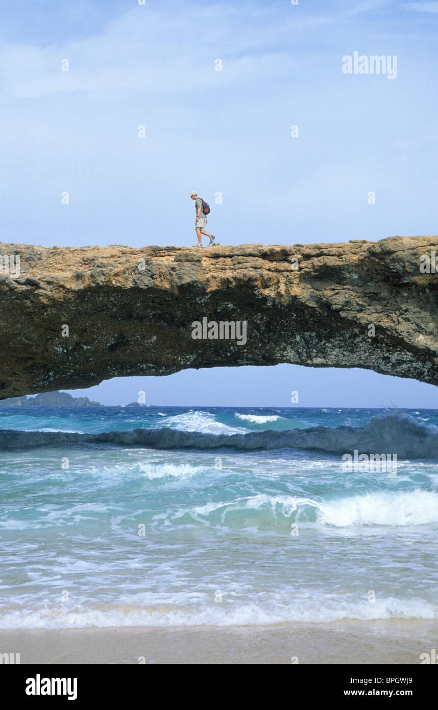 Man walking on Natural Arch Stock Photo - Alamy