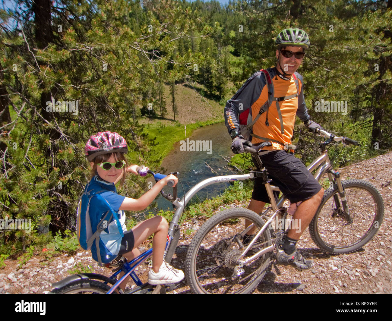 Man and child riding bikes Stock Photo - Alamy