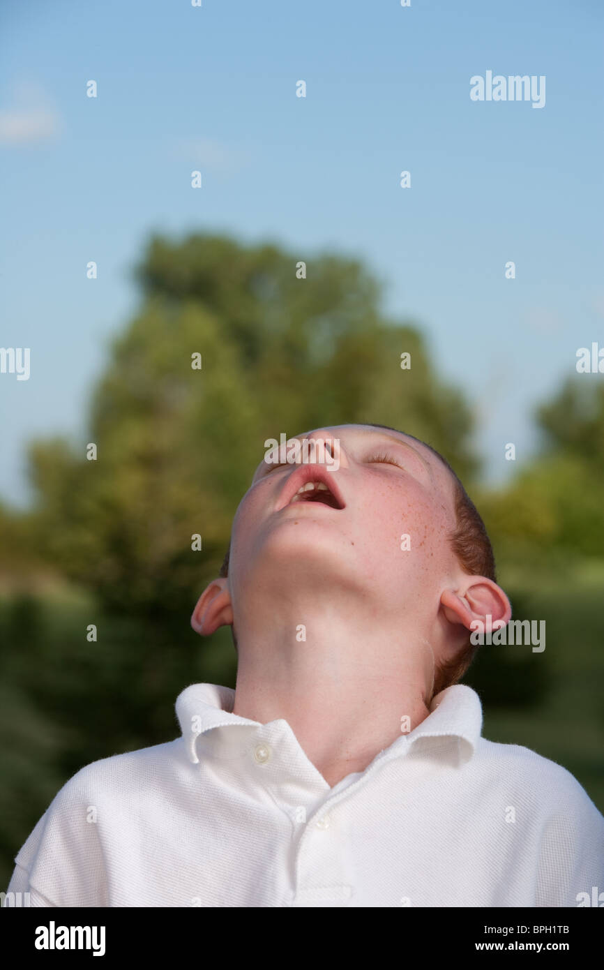 Goofy red haired kid looking up Stock Photo - Alamy