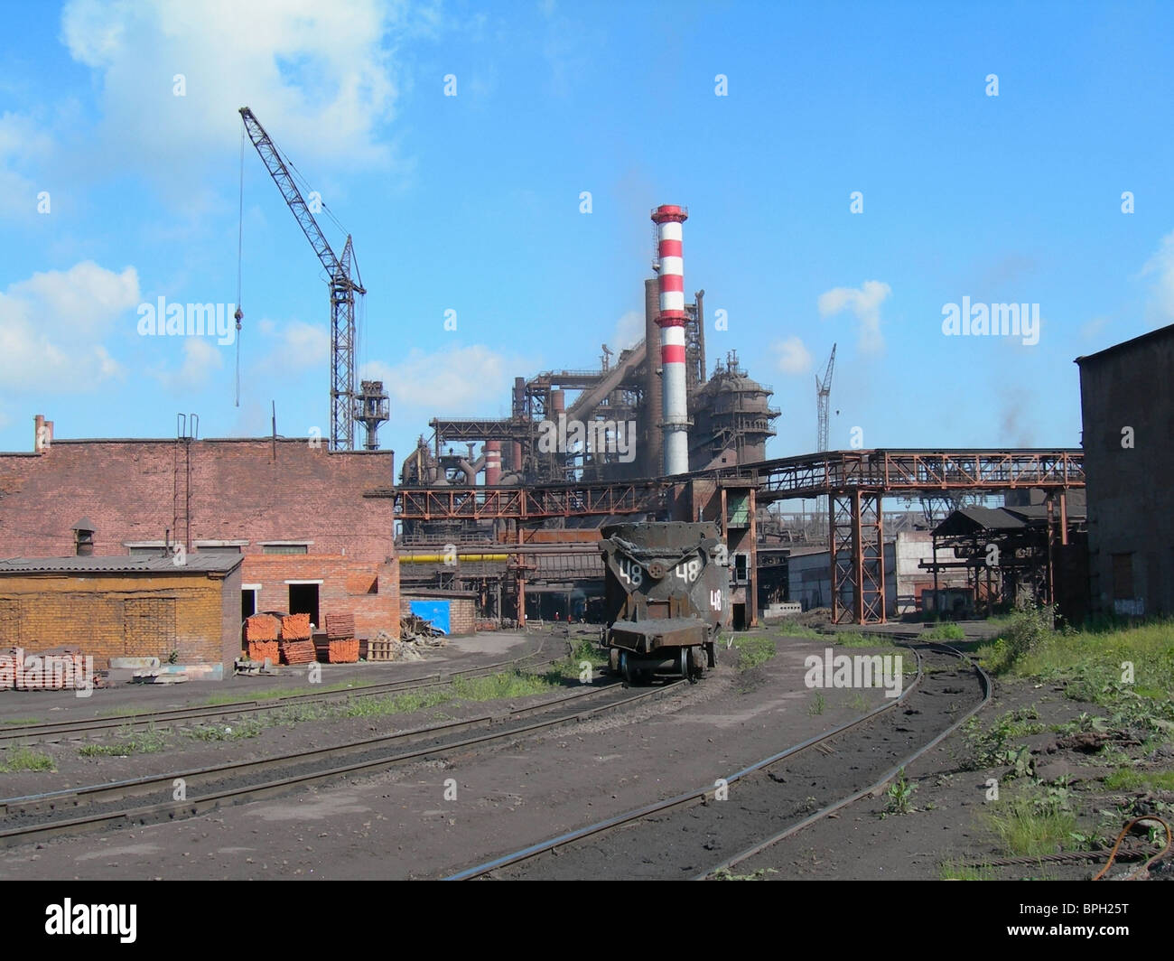 Metallurgical works with blast furnaces, chimney flue and railway in ...