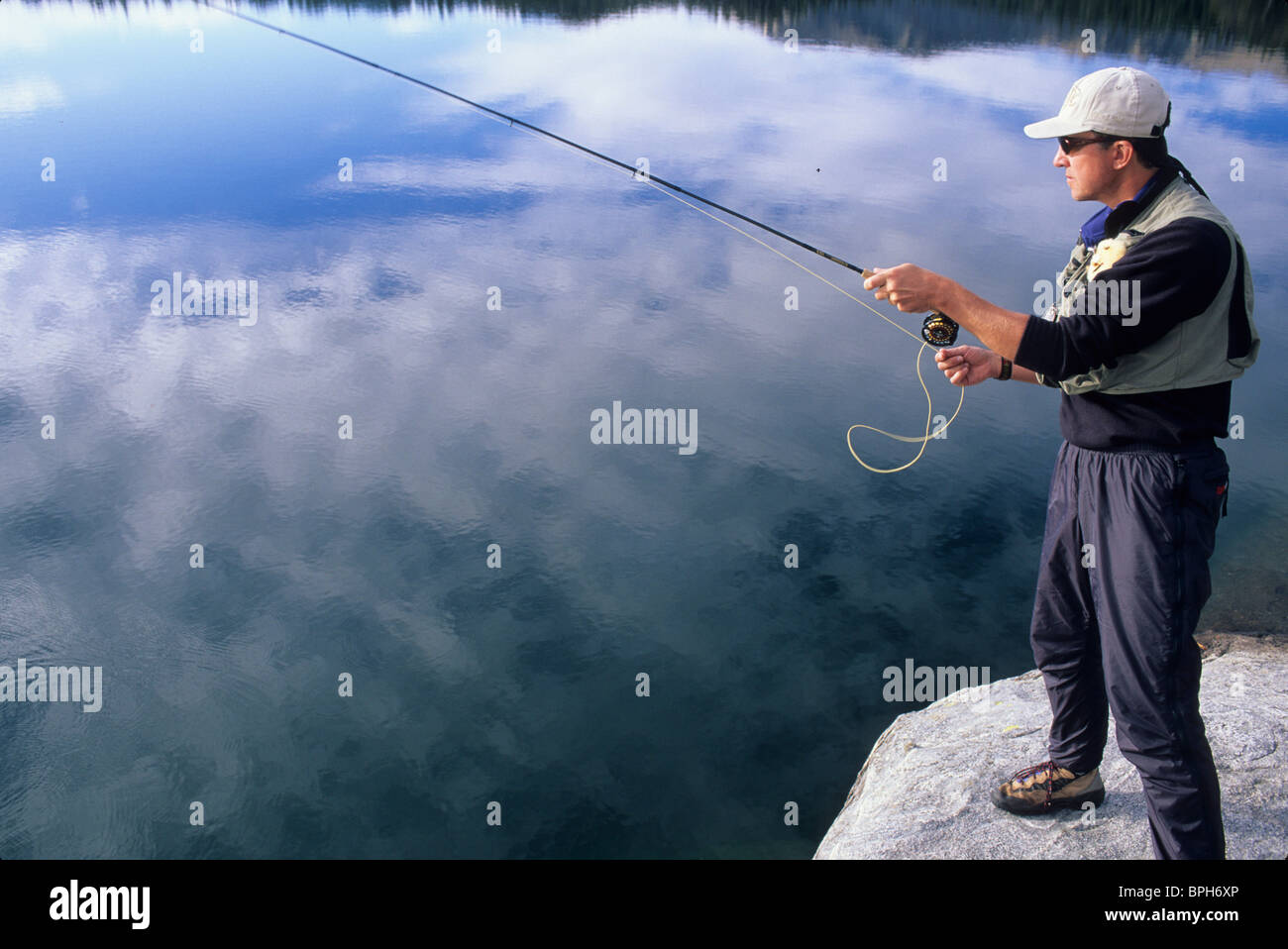 Man fly fishing Stock Photo - Alamy