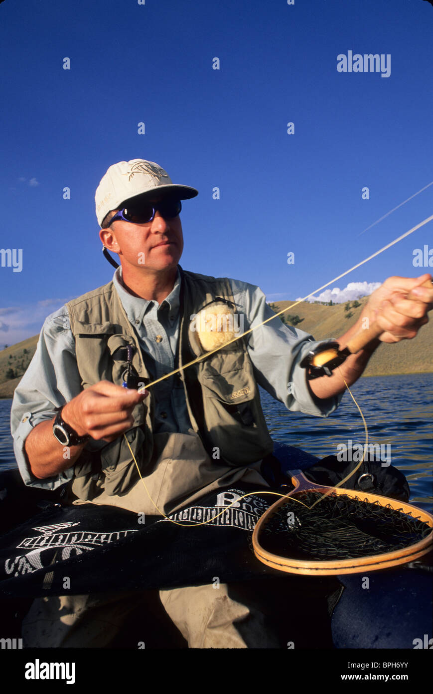 Man fly fishing Stock Photo - Alamy