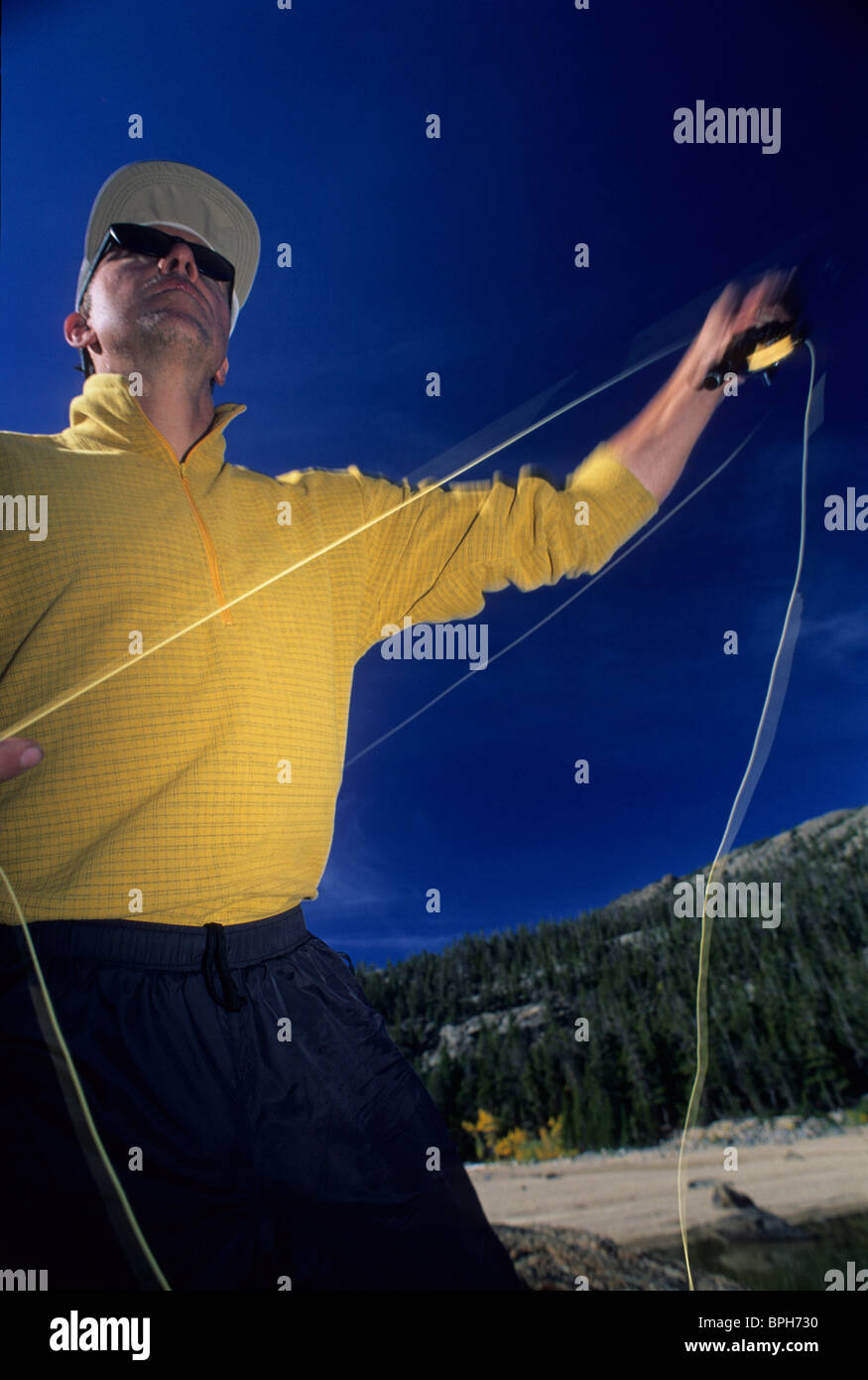 Man fly fishing Stock Photo - Alamy