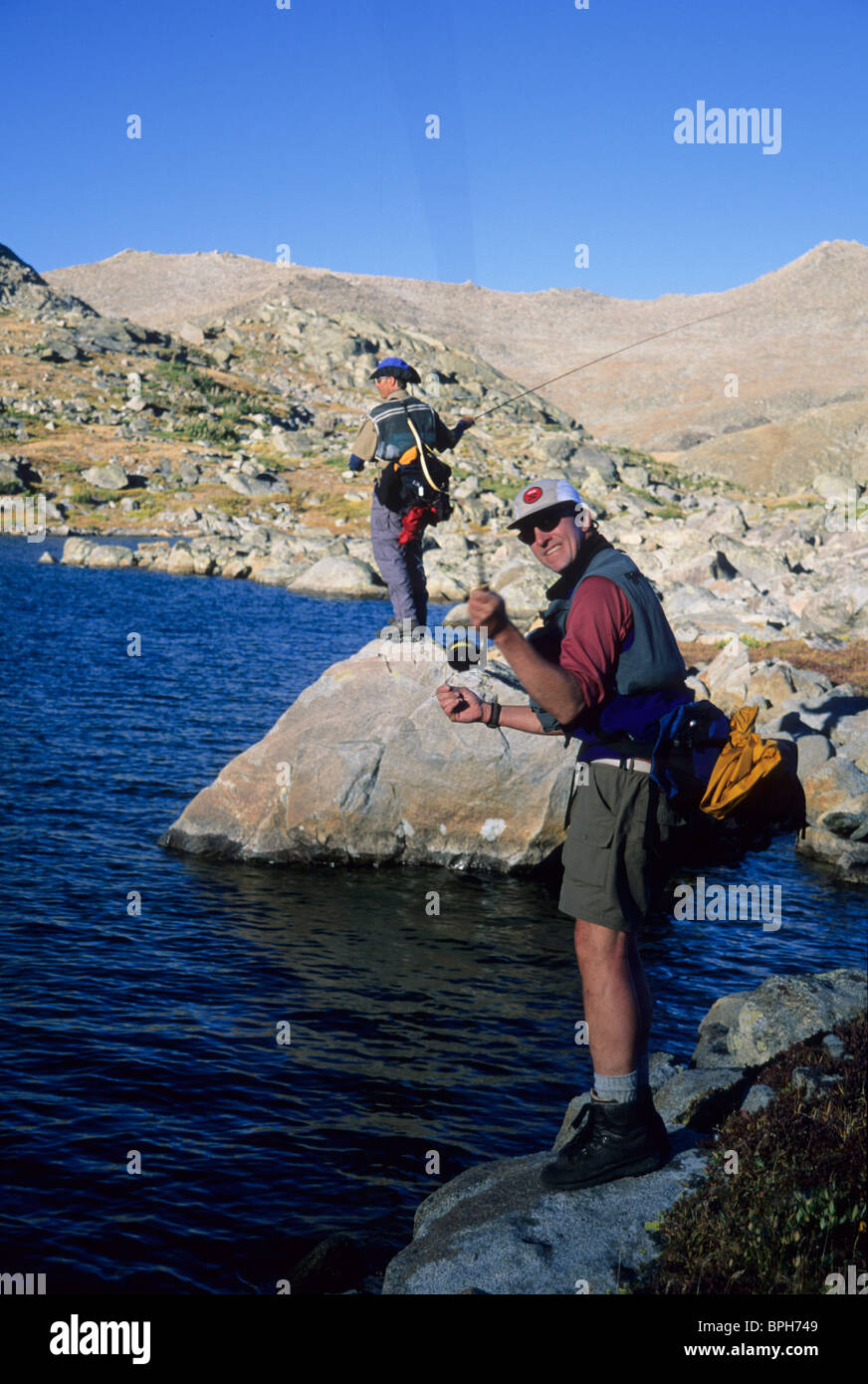 Two men fly fishing Stock Photo - Alamy