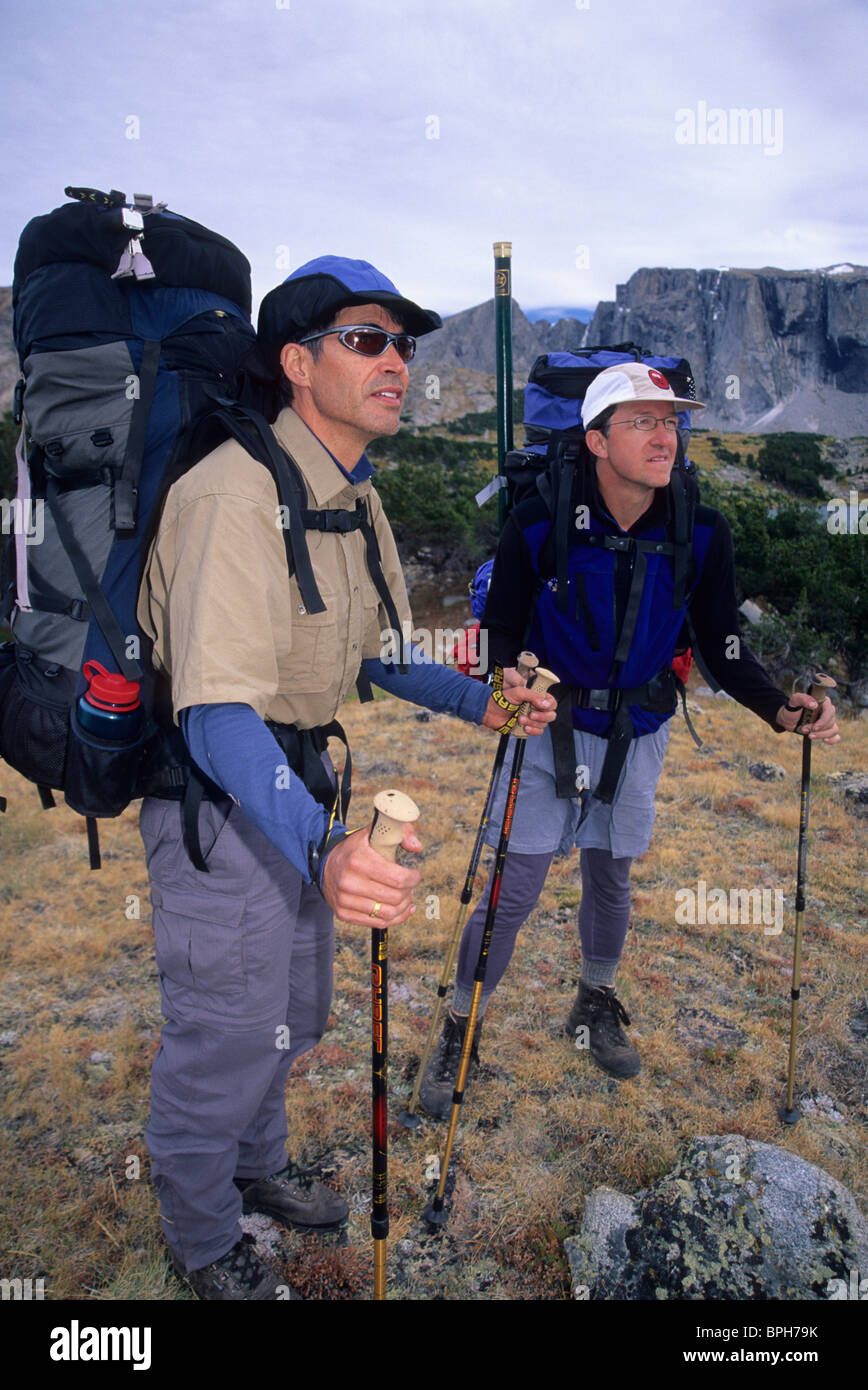 Men backpacking to fishing hole Stock Photo - Alamy