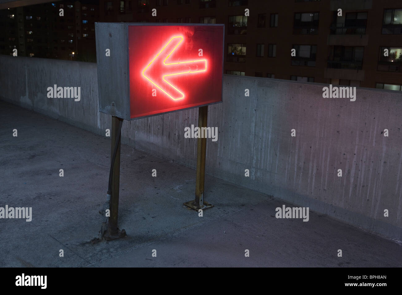 Illuminated arrow sign in a garage, Theater District, Boston, Suffolk ...