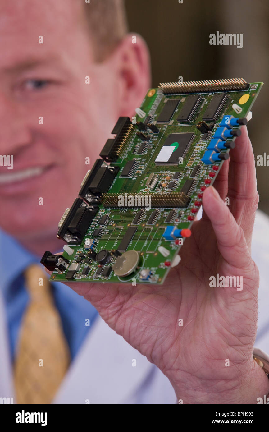 Engineer showing a micro controller circuit board Stock Photo - Alamy