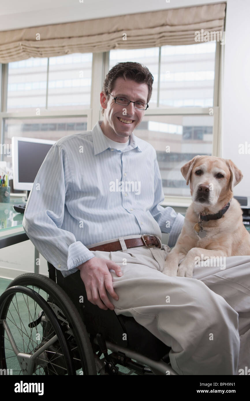 Man in a wheelchair with a service dog Stock Photo - Alamy