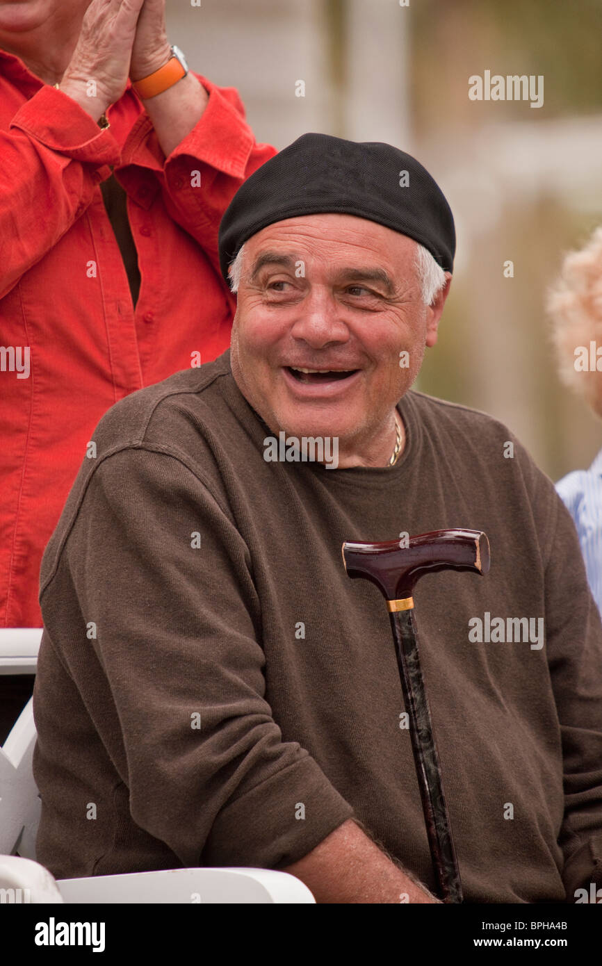 Man watching a game and laughing Stock Photo - Alamy