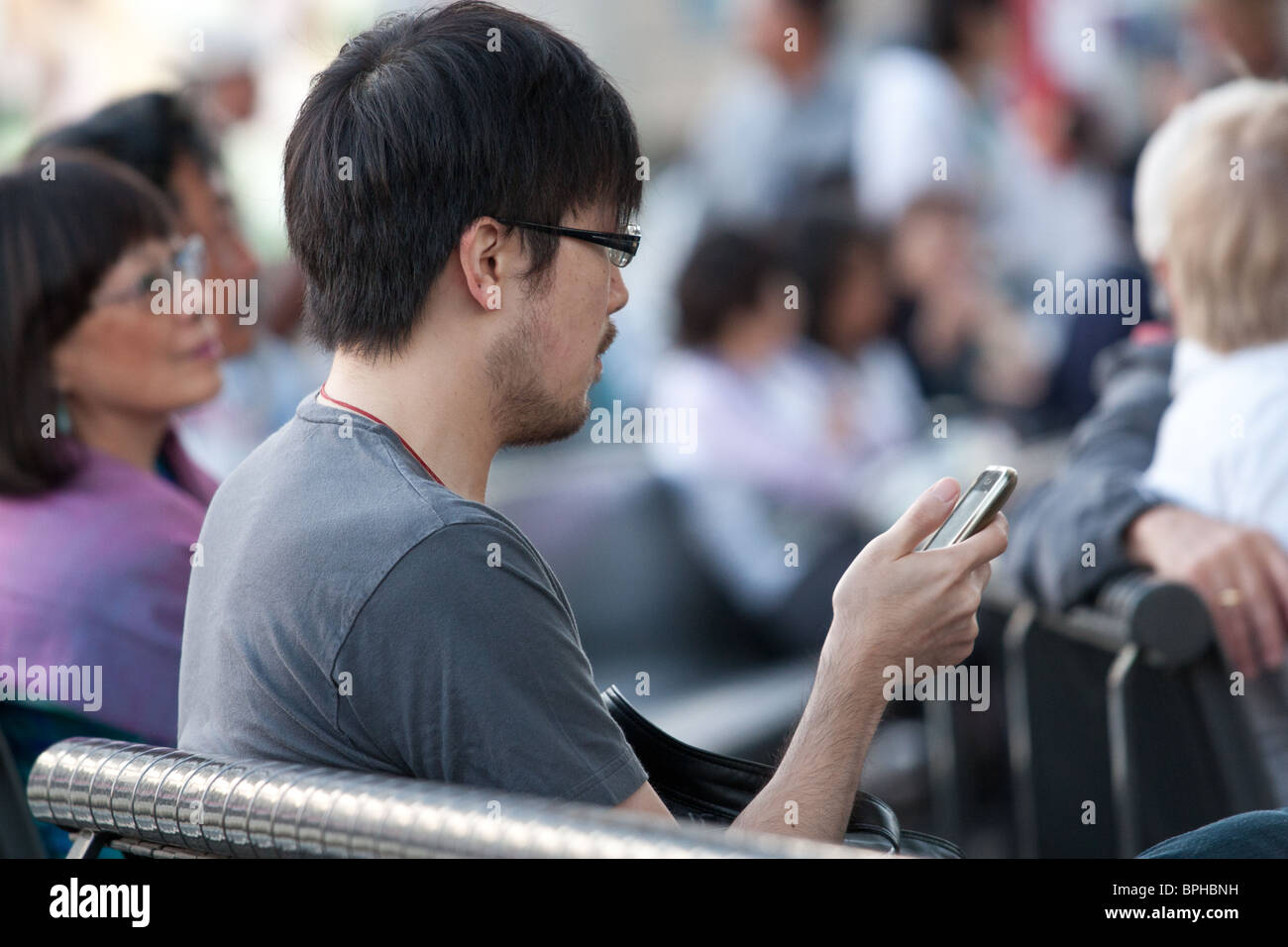 Asian man texting using iphone mobile phone outdoor Stock Photo - Alamy