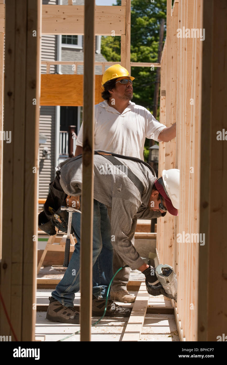 Carpenters building framing using nail gun Stock Photo - Alamy