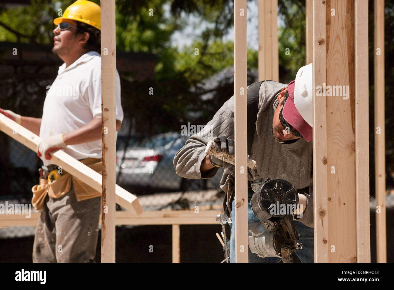 Carpenters working at a construction site Stock Photo - Alamy