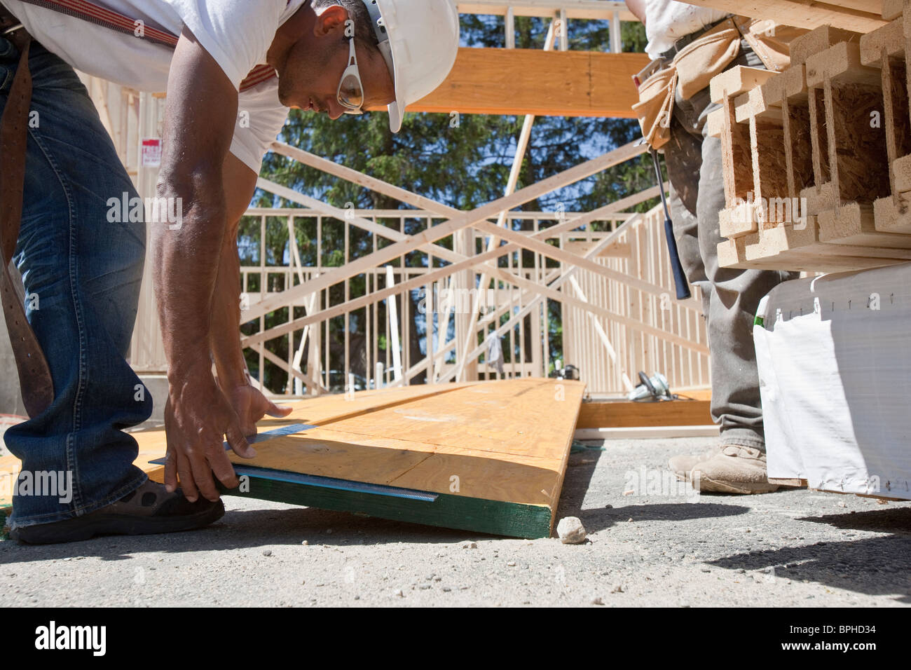 Carpenters working on a lamination beam at a construction site Stock ...