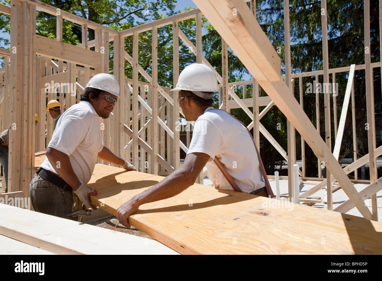 Carpenters working on a lamination beam at a construction site Stock ...