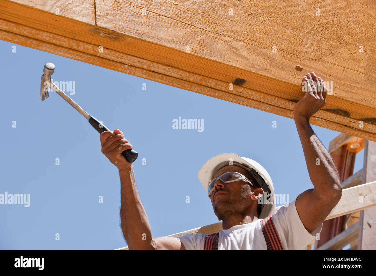 Carpenter hammering a beam Stock Photo - Alamy
