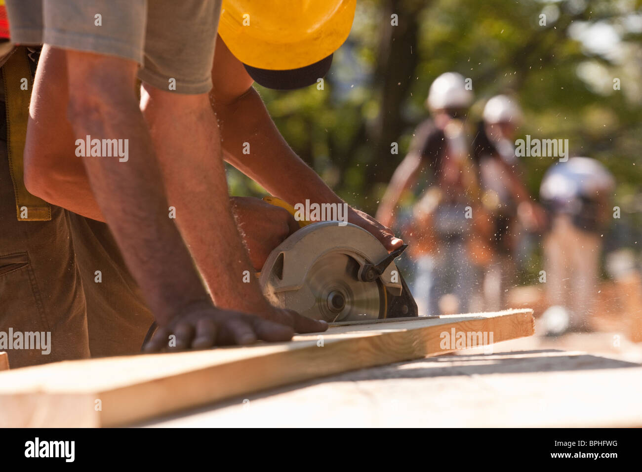 Carpenters using a circular saw at a construction site Stock Photo - Alamy