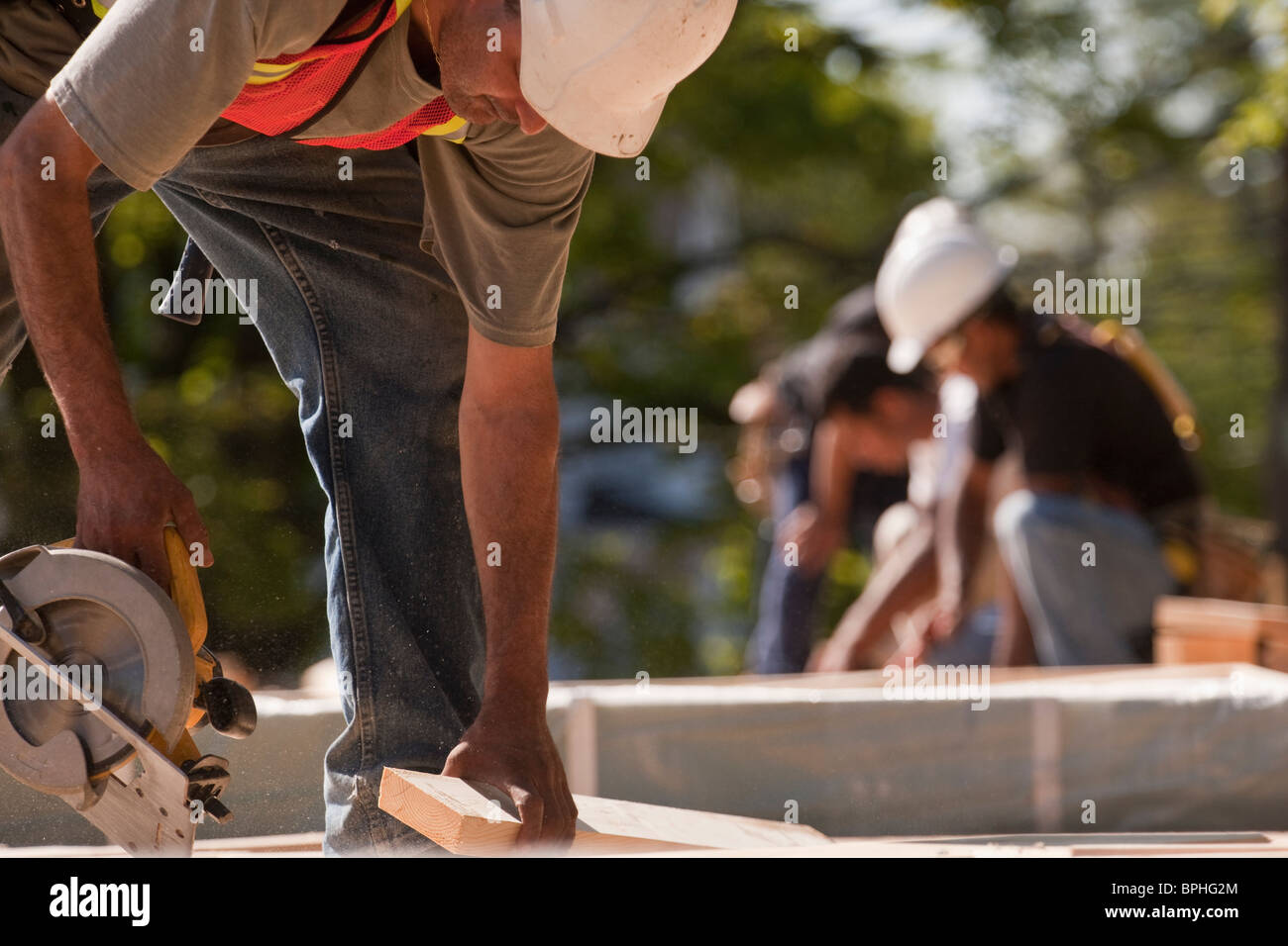Carpenters using circular saw at a construction site Stock Photo - Alamy