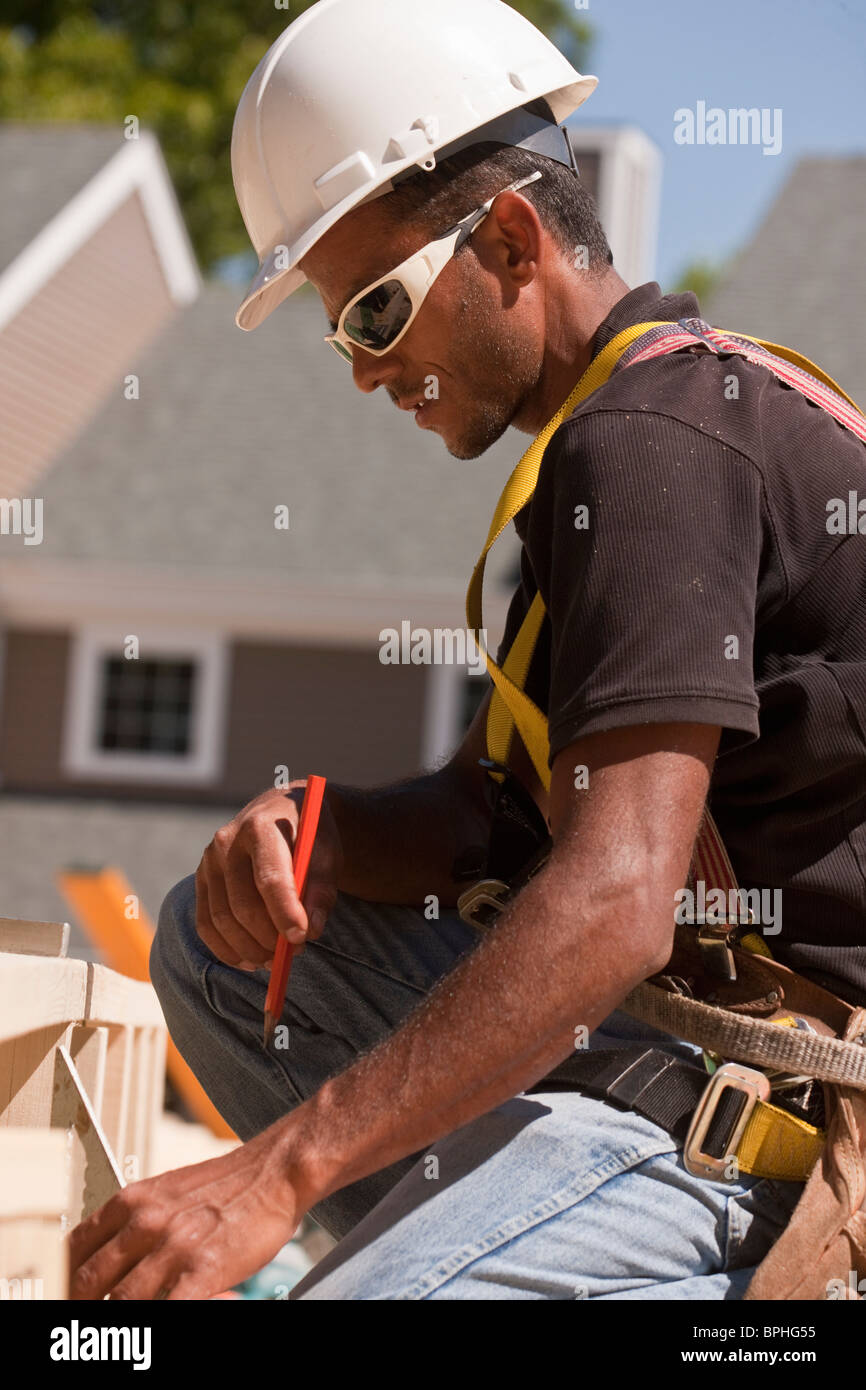 Carpenter checking measurements with triangle Stock Photo - Alamy