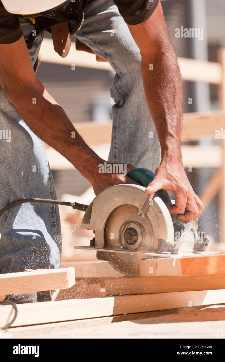 Carpenter using a circular saw at a construction site Stock Photo - Alamy