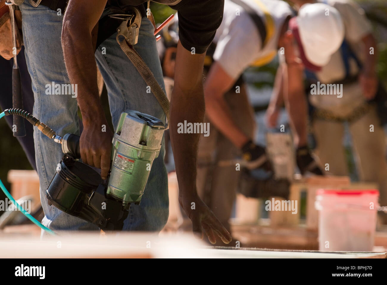Hispanic construction worker nail gun hi-res stock photography and ...
