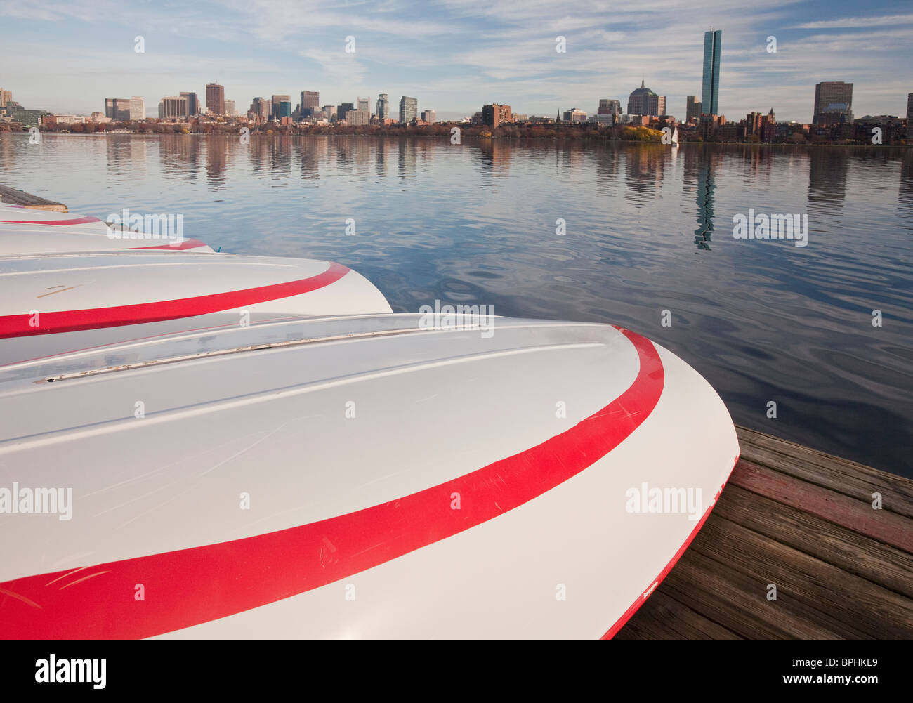 Boats at the riverside with buildings in the background, Charles River ...
