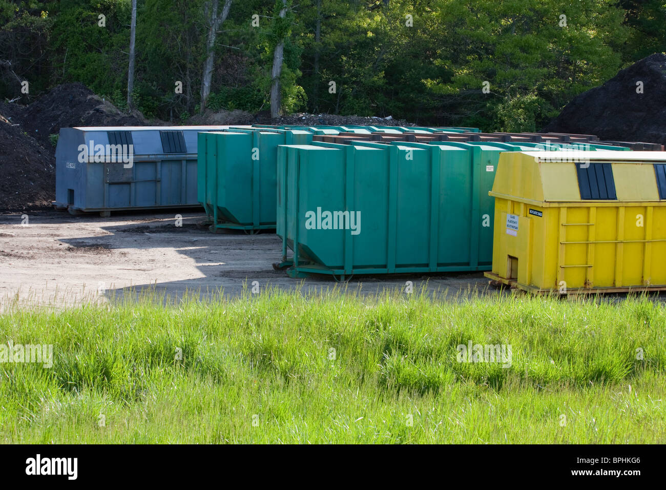 Four recycling containers at a public recycling center, two for trash ...