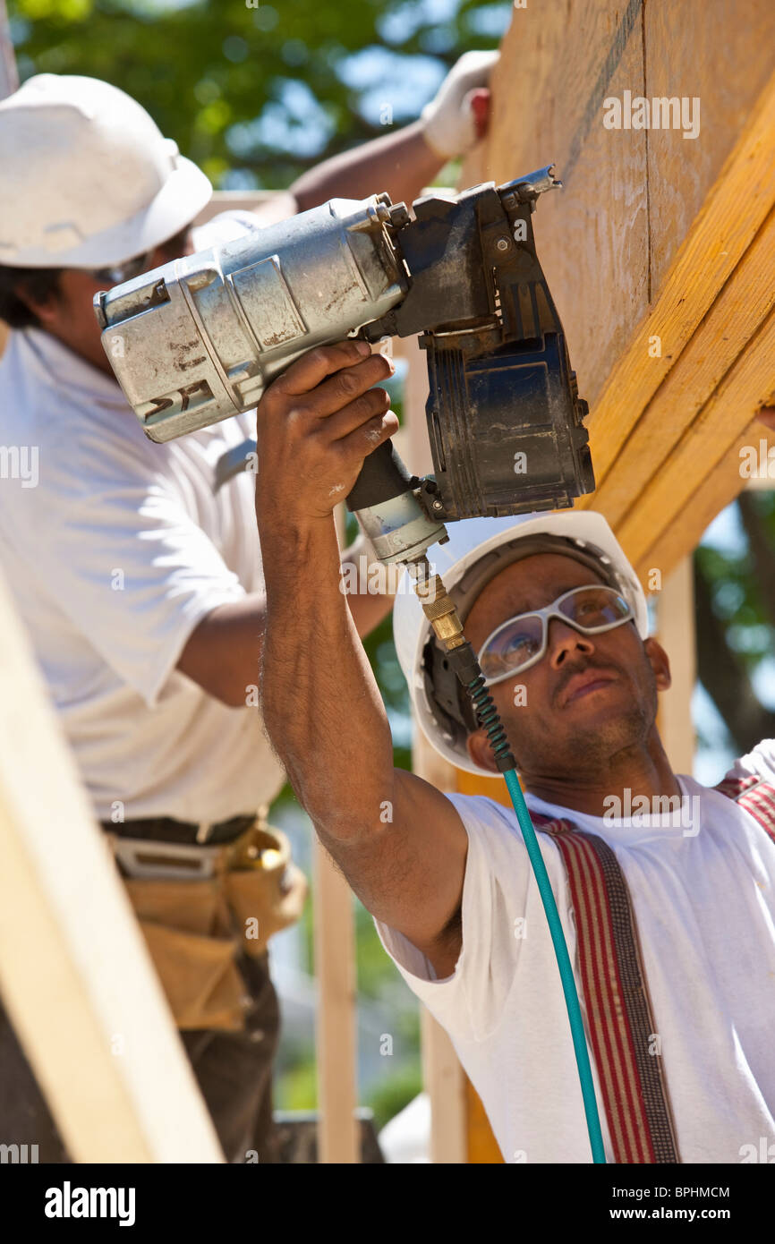 Carpenters nailing beams Stock Photo - Alamy