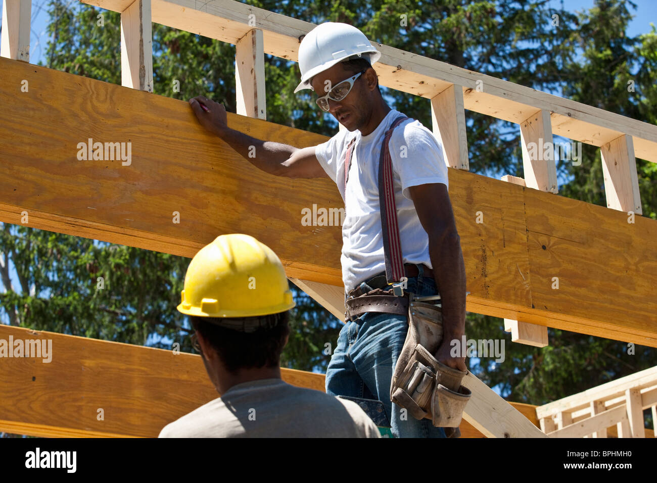 Carpenters putting up beams Stock Photo - Alamy