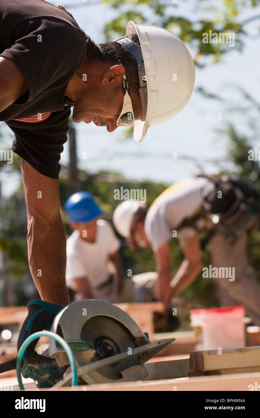 Carpenters using circular saw at a construction site Stock Photo - Alamy