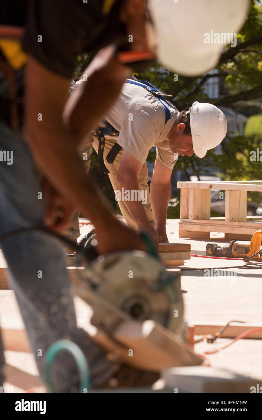 Carpenters using circular saw at a construction site Stock Photo - Alamy
