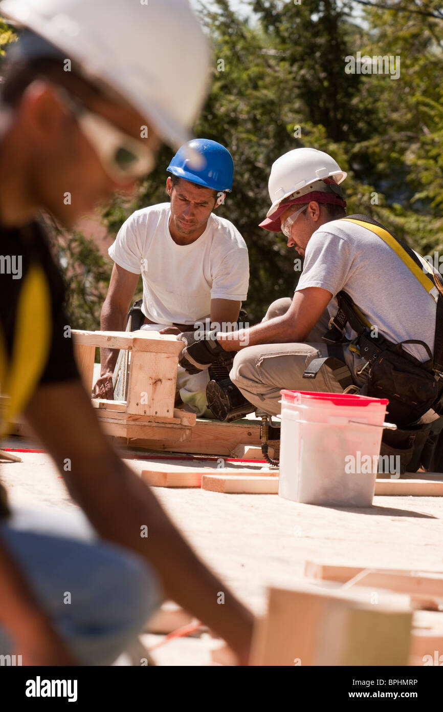 Carpenters working with framing materials Stock Photo - Alamy