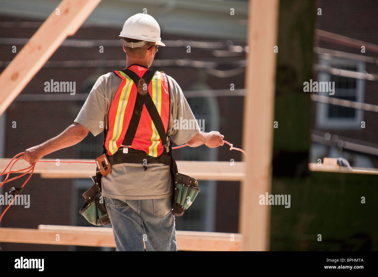 Carpenter coiling a power cable Stock Photo - Alamy