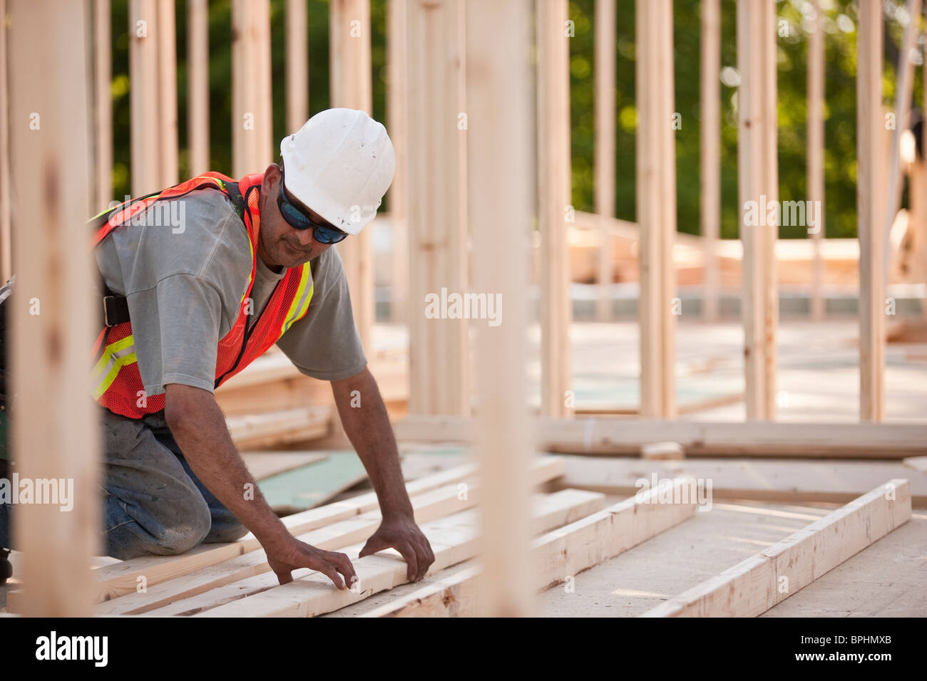 Carpenter working on a house framing Stock Photo - Alamy