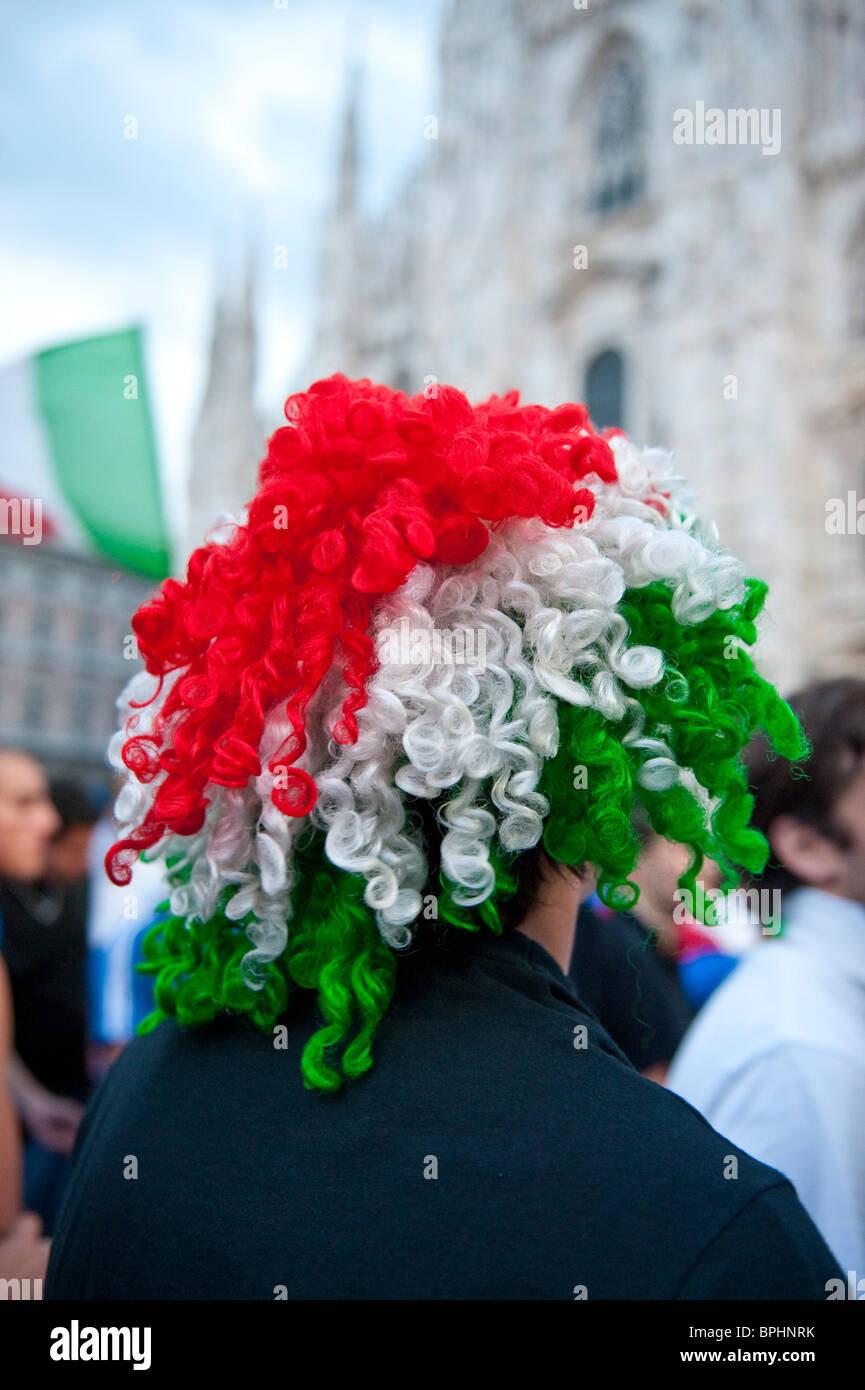 Football fan wearing wig with italian flag colours while watching Italy ...