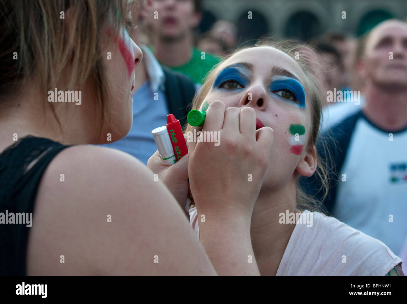 Football fan paint their faces with italian flag colours while watching ...