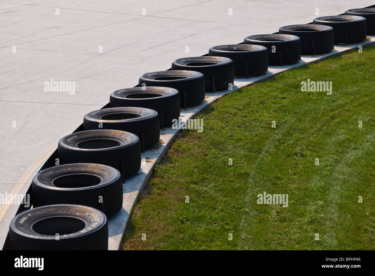 A symmetrical section of a race track with old tires bumpers from above ...