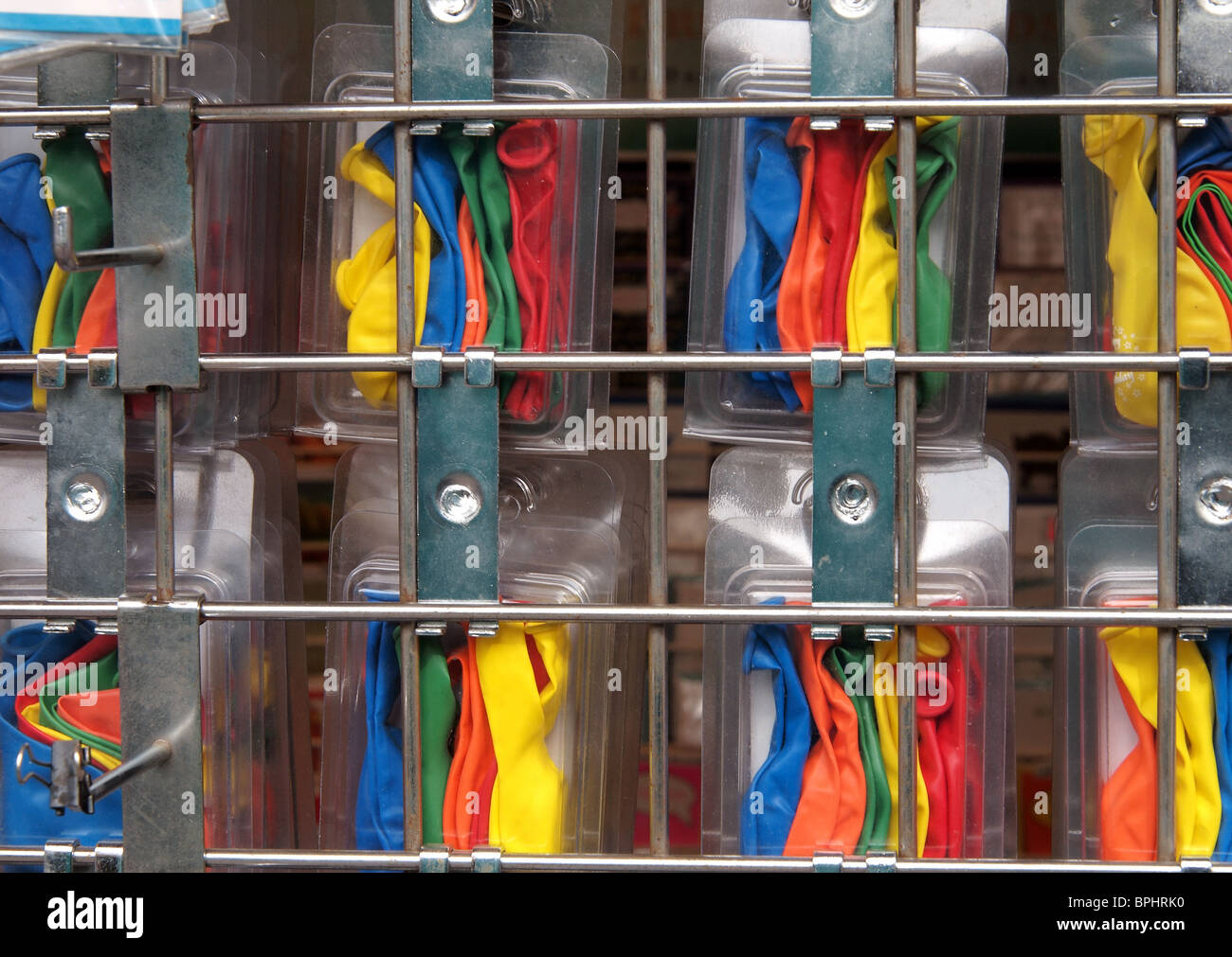 Packets of balloons hanging on a metal rack Stock Photo - Alamy