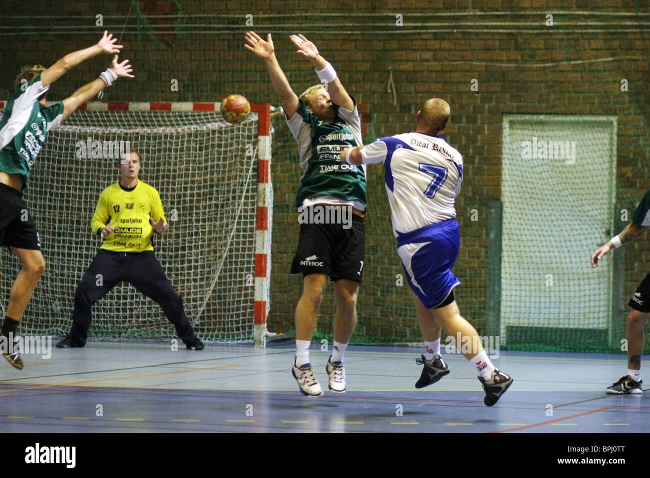 Action photo from a handball game between IFK Nyköping (white and blue ...