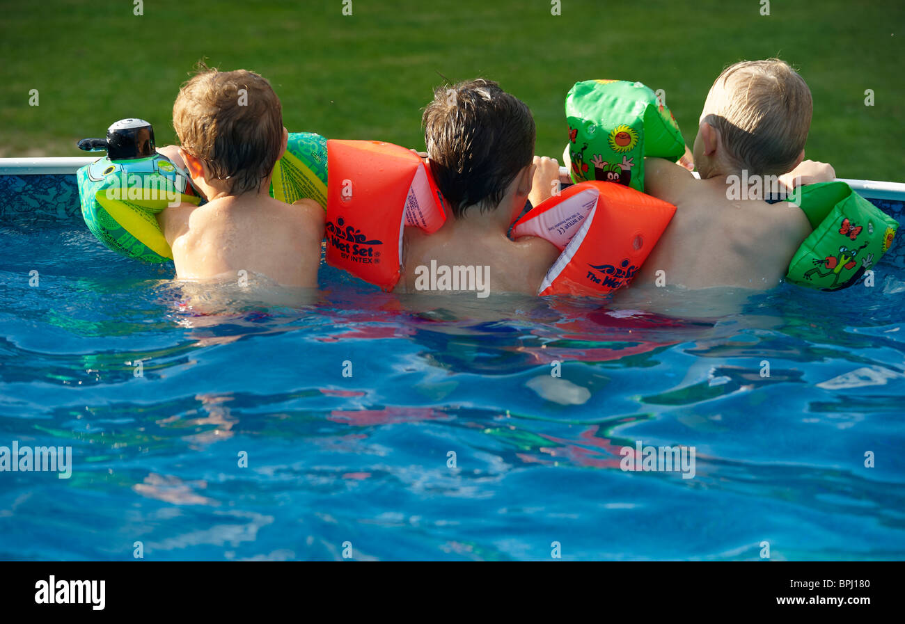 young blond boy playing in a swimming pool Stock Photo - Alamy
