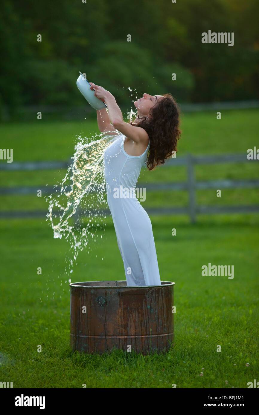 Woman pouring water over head hi-res stock photography and images - Alamy