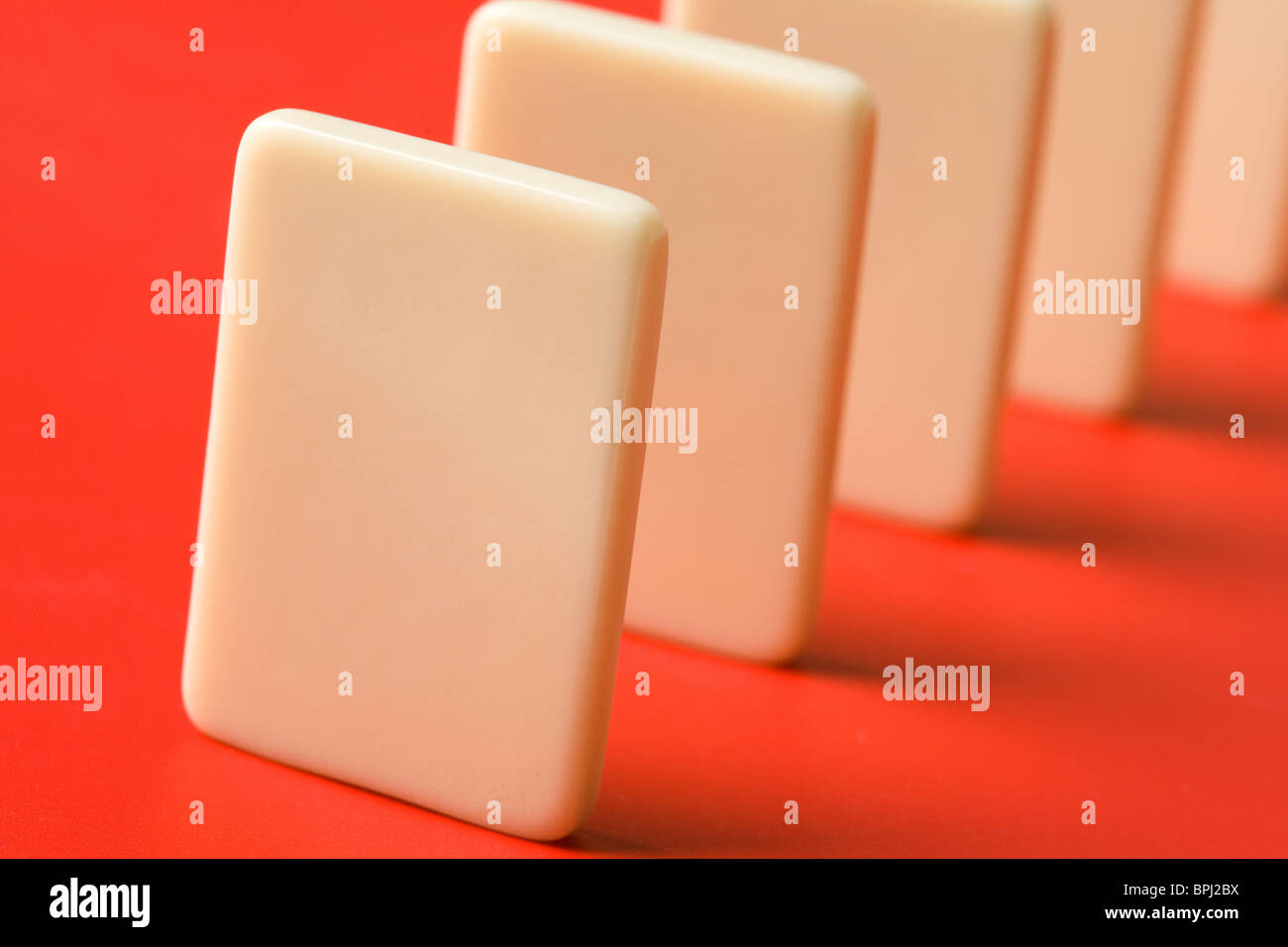 Domino with red background, Concept of Cause or Teamwork Stock Photo ...
