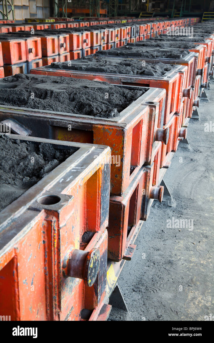 Row of carload with various materials in a factory Stock Photo - Alamy