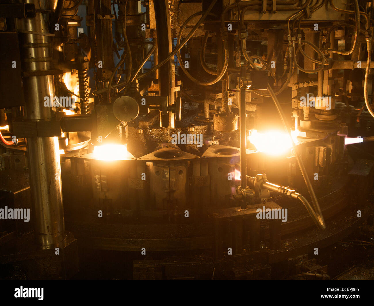 the production line of wine glasses where molten glass of around 1100 ...