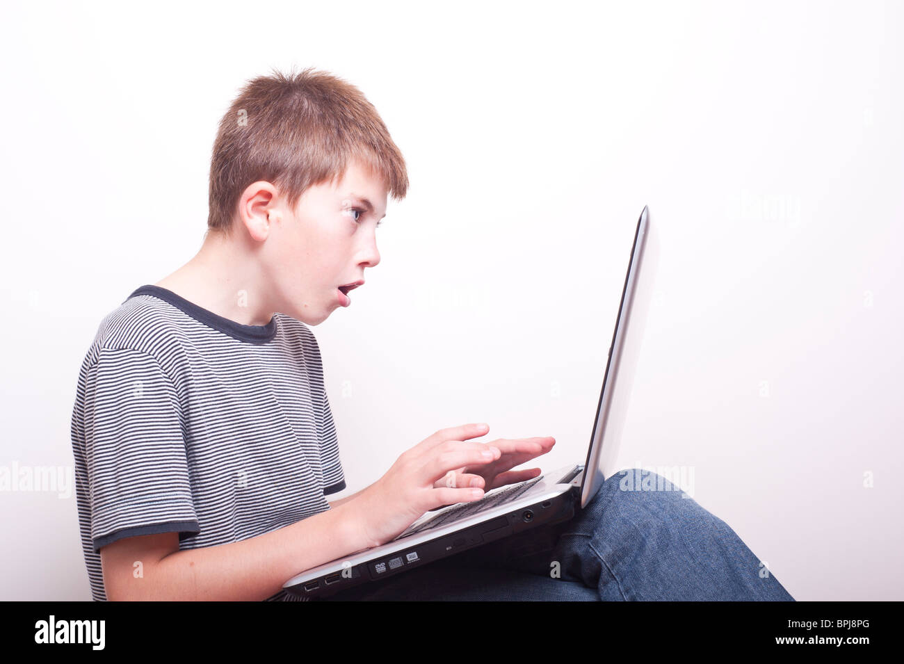 A MODEL RELEASED picture of a 10 year old boy looking shocked while ...